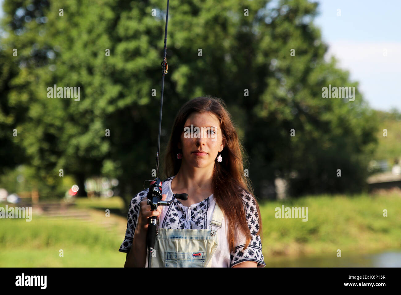 Woman with freckles and hot pants while fishing Stock Photo - Alamy