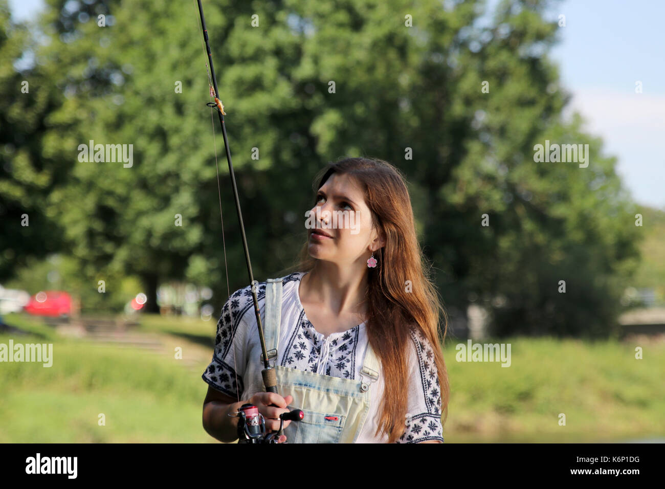 Woman with freckles and hot pants while fishing Stock Photo - Alamy