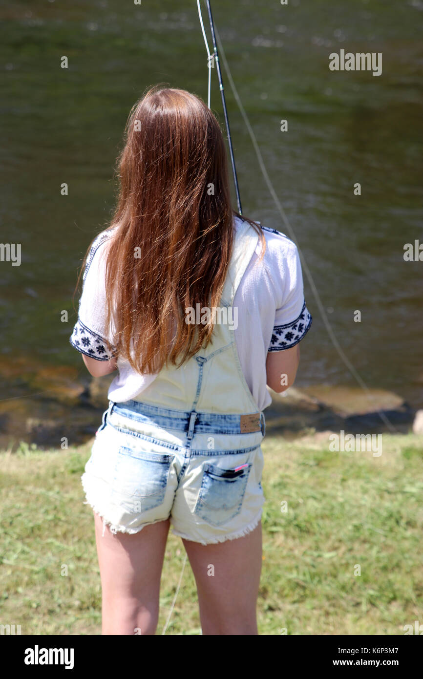 Woman with freckles and hot pants while fishing Stock Photo - Alamy