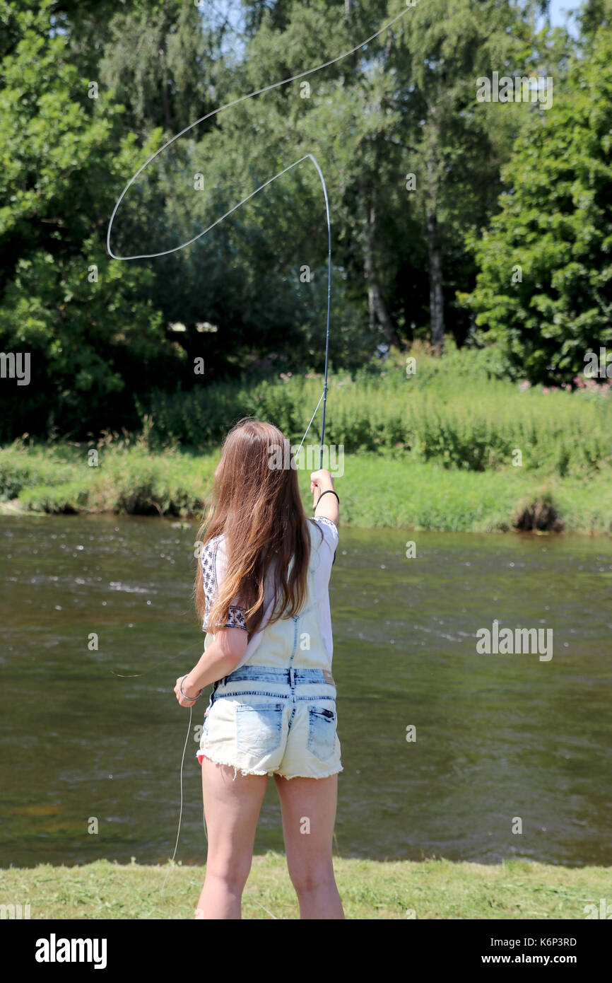 Woman with freckles and hot pants while fishing Stock Photo - Alamy