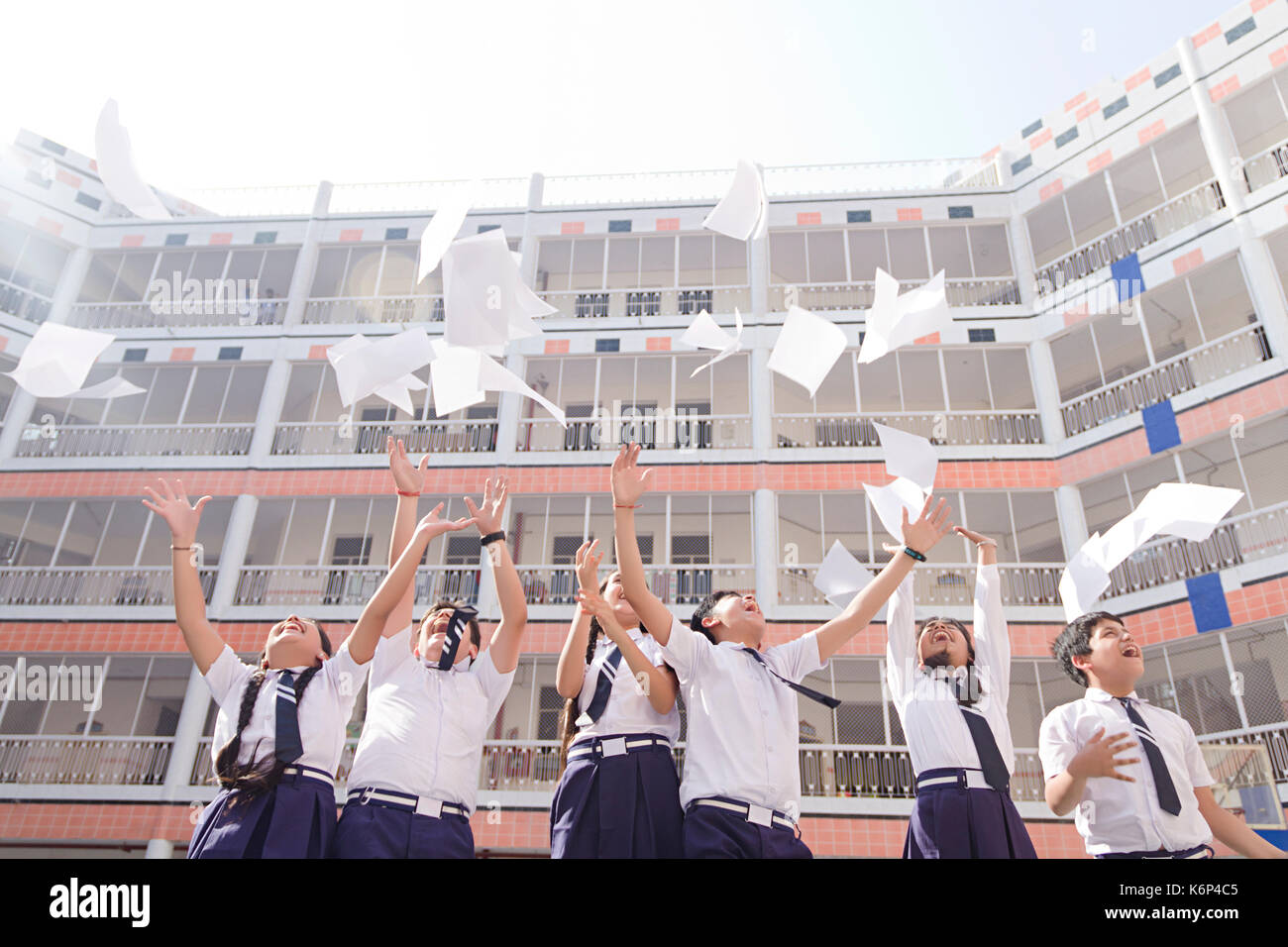 Boys throwing papers hi-res stock photography and images - Alamy