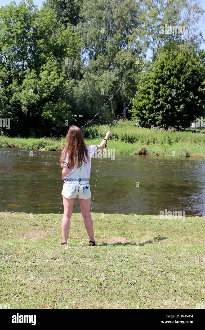 Woman with freckles and hot pants while fishing Stock Photo - Alamy