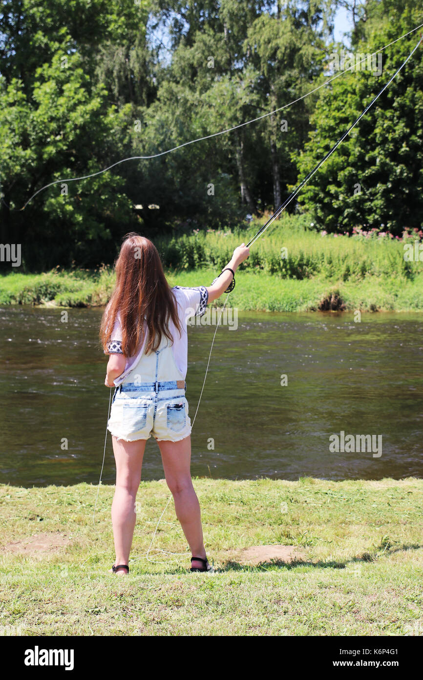 Woman with freckles and hot pants while fishing Stock Photo - Alamy