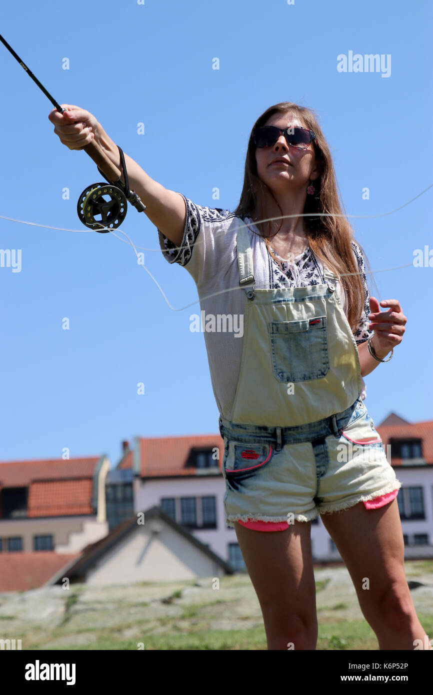 Woman with freckles and hot pants while fishing Stock Photo - Alamy