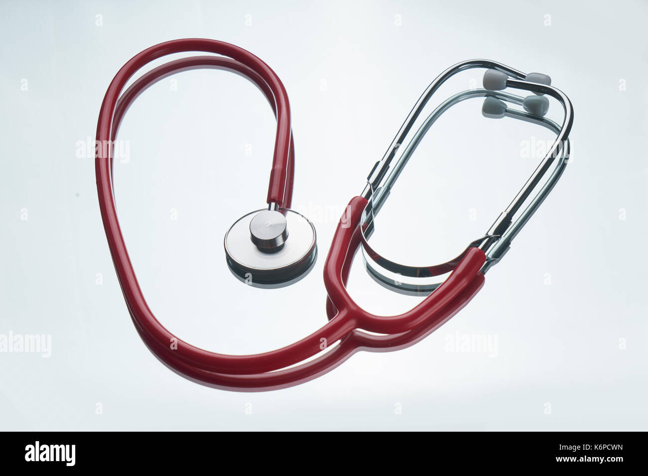 Red color stethoscope with reflection on glossy background Stock Photo ...