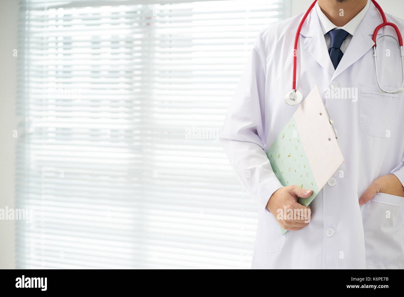 Doctor with a stethoscope and taking notes with bright background Stock ...