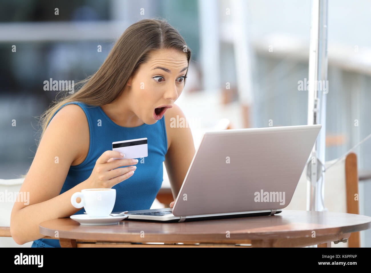 Single amazed woman finding an offer buying on line with a laptop and ...