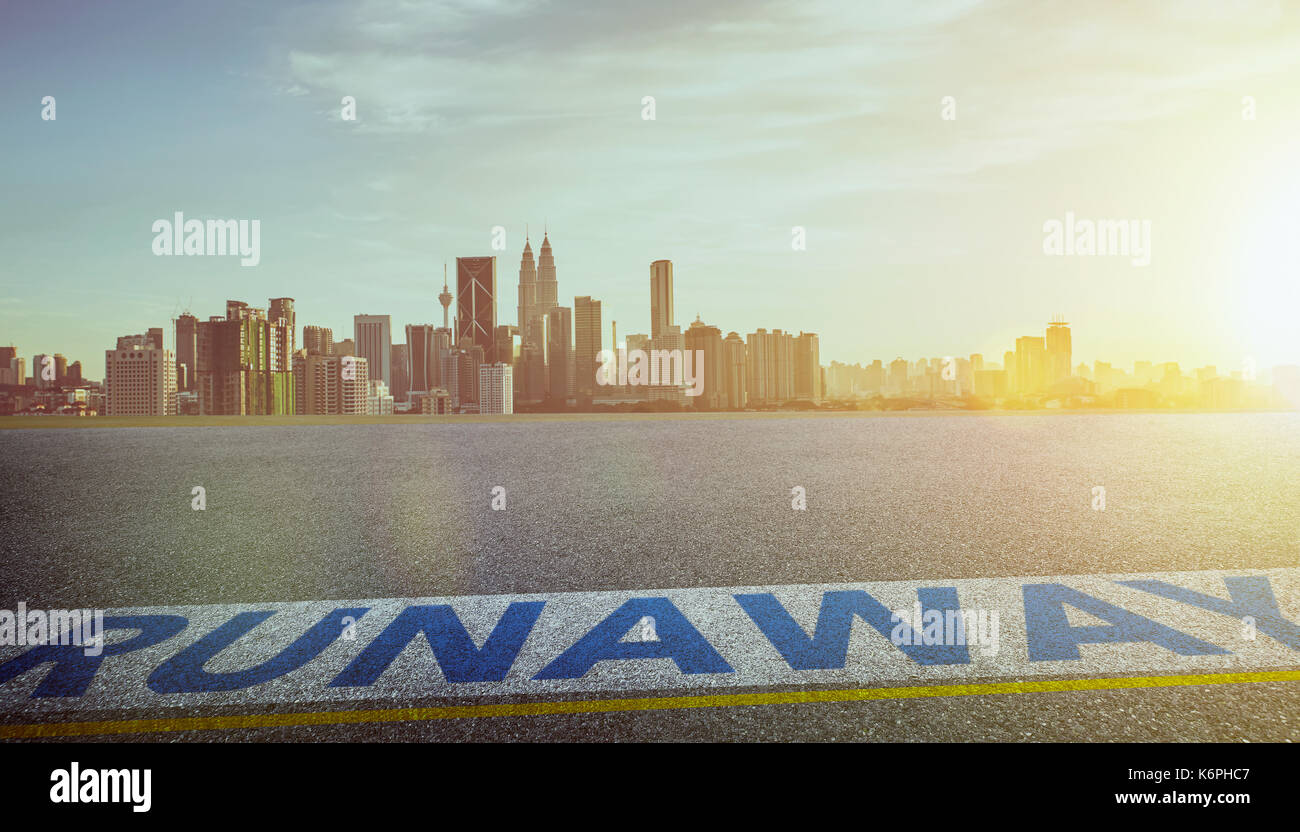 View of the empty asphalt road with runaway word and city skyline ...