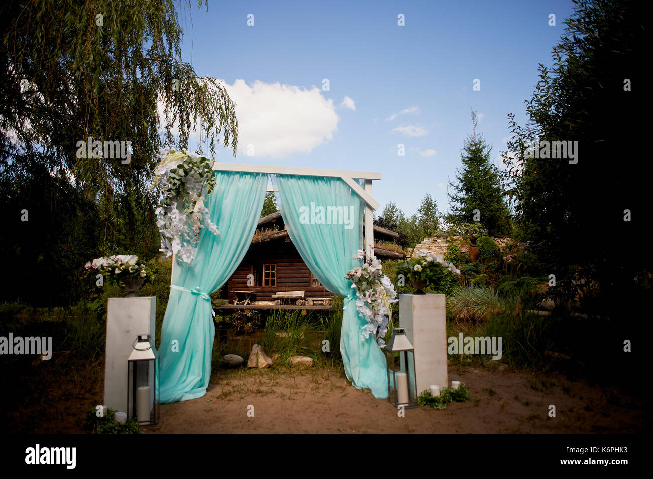 Wedding Arch of turquoise color on background lake Stock Photo - Alamy