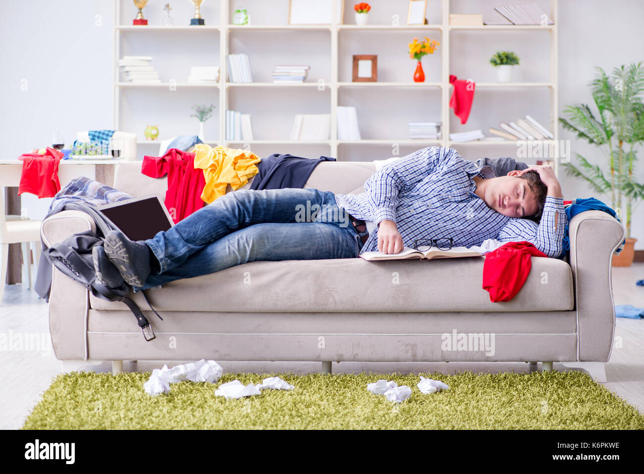 Young man working studying in messy room Stock Photo - Alamy