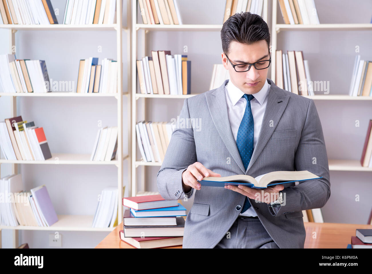 Business law student working studying in the library Stock Photo - Alamy