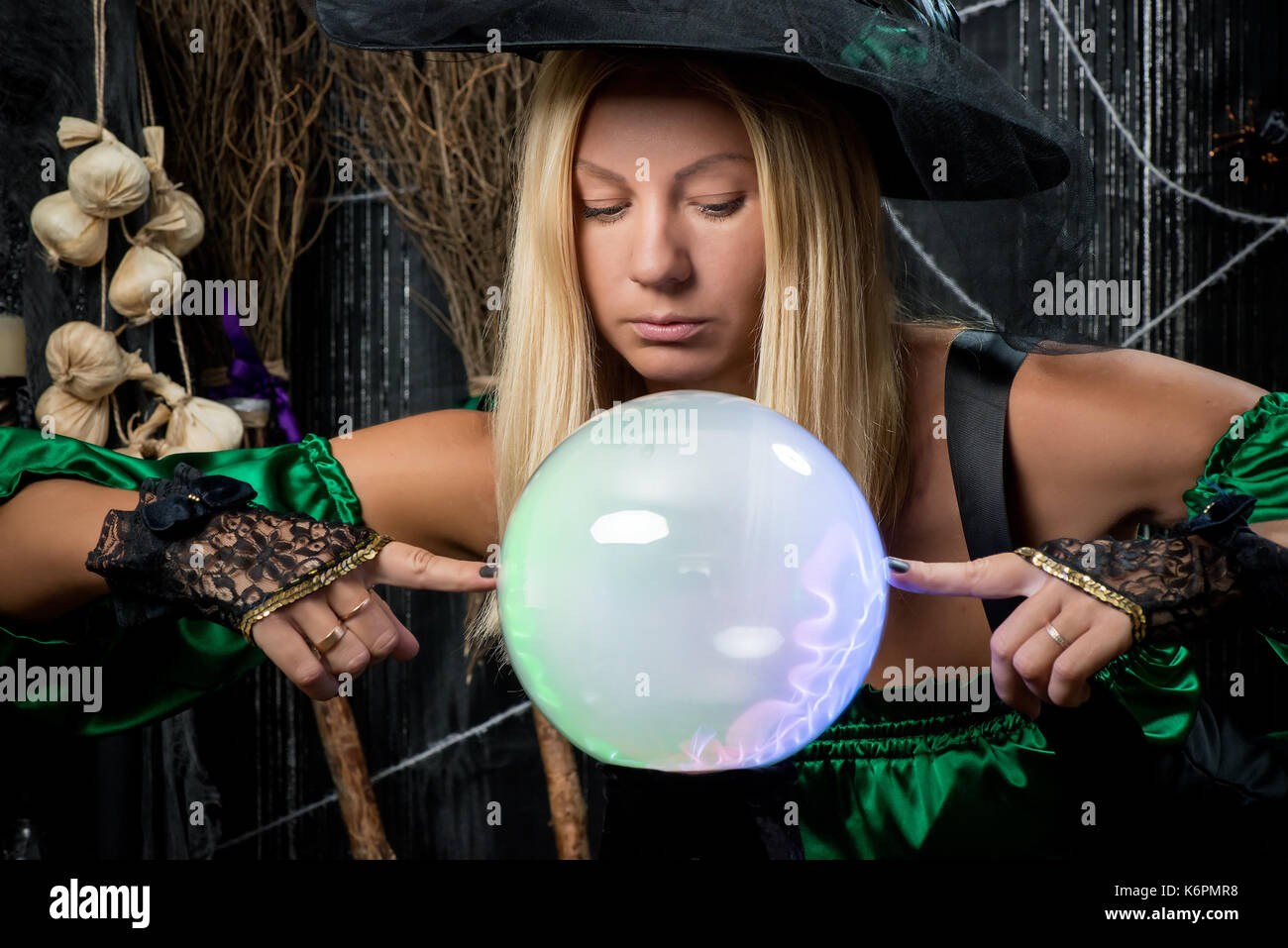 The witch looks into his magic ball and tries to see the future Stock ...