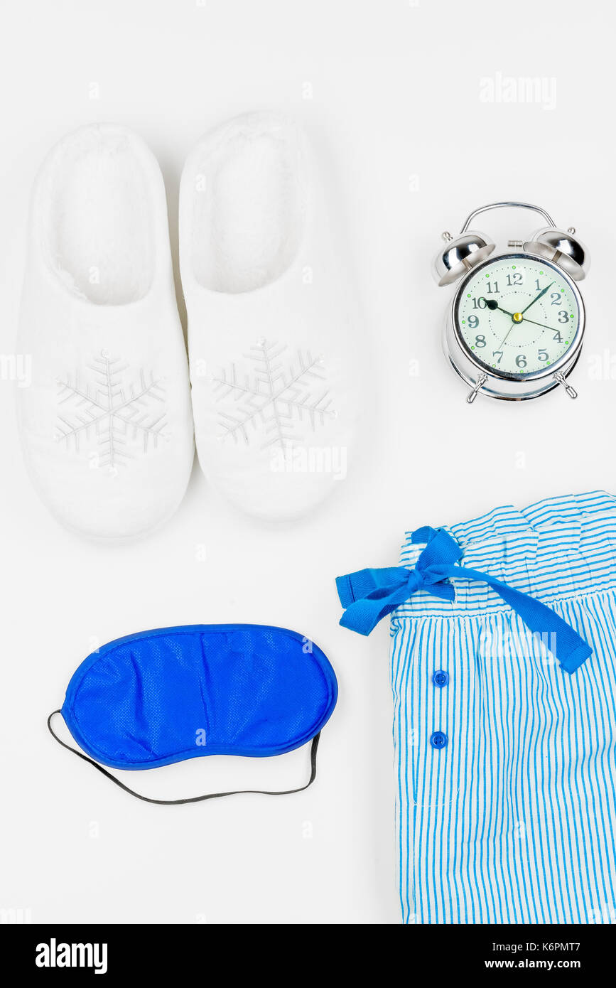 objects with a slipper and pajama objects view from above on a white ...