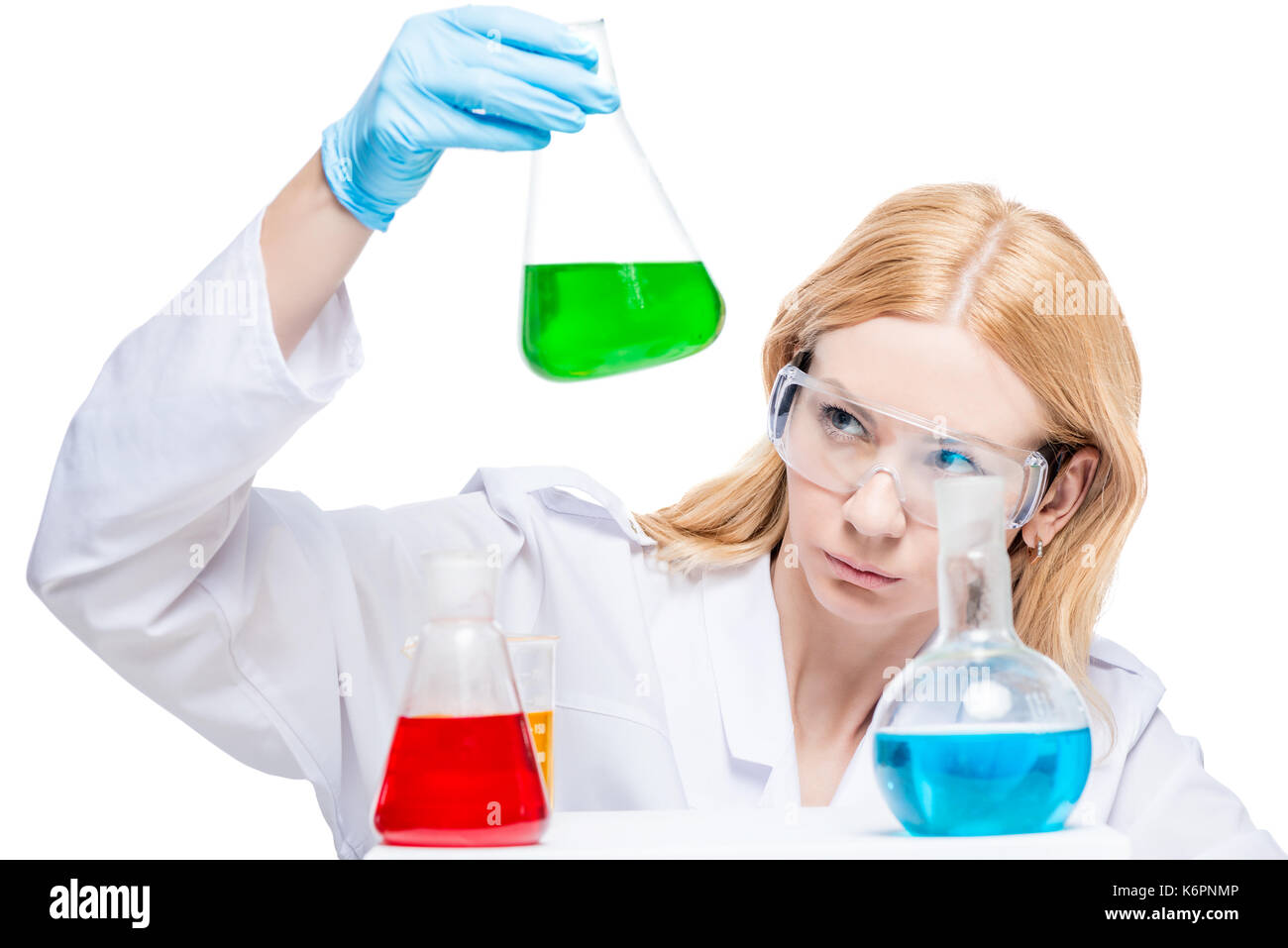 A professional chemist with test tubes in glasses and gloves makes an ...