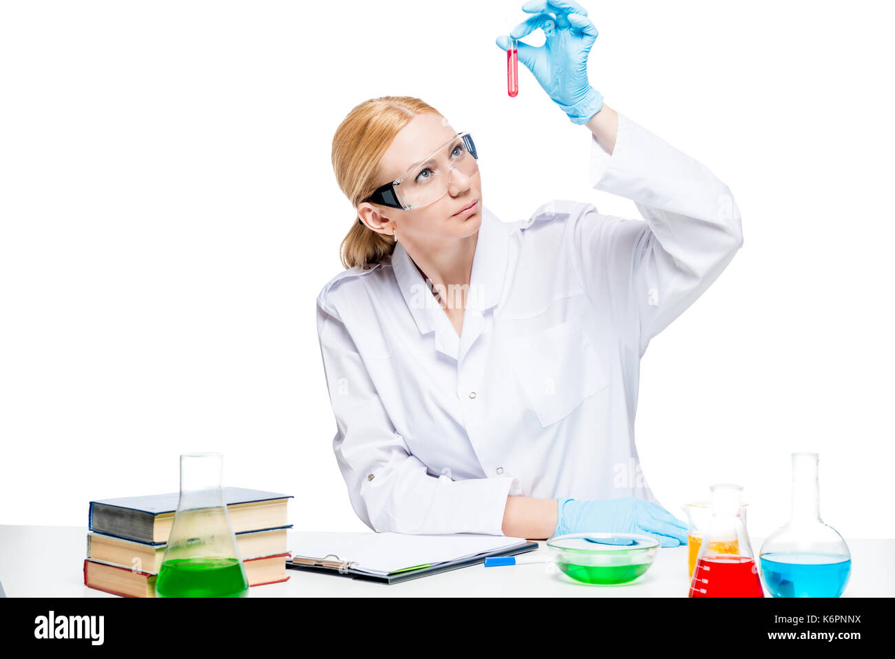 Specialist chemist biologist with test tubes at the table makes ...