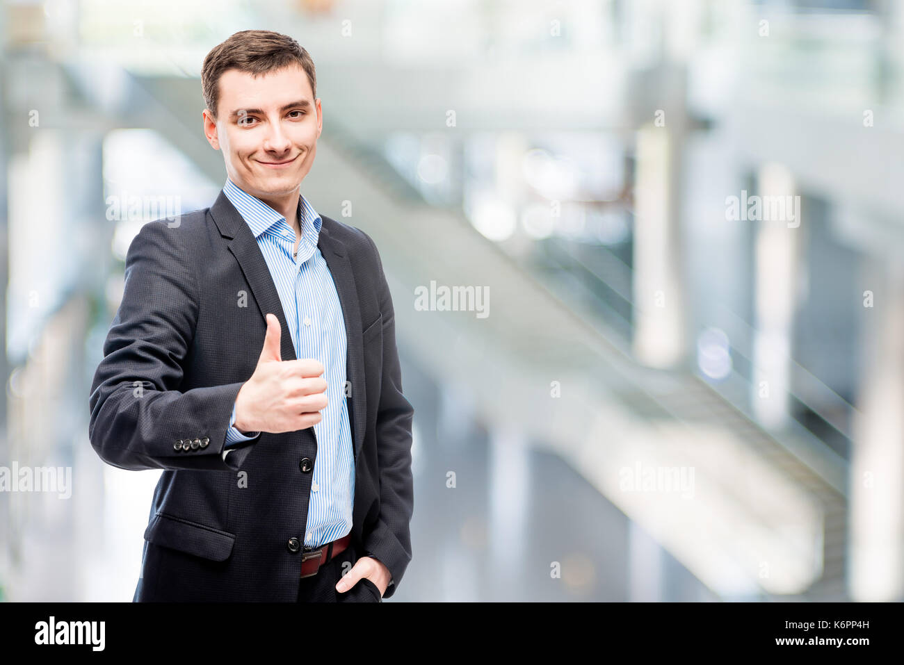 Smiling young male business executive in office portrait Stock Photo ...