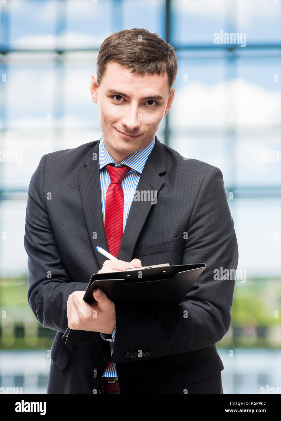 Portrait of a successful businessman signing an important contract ...