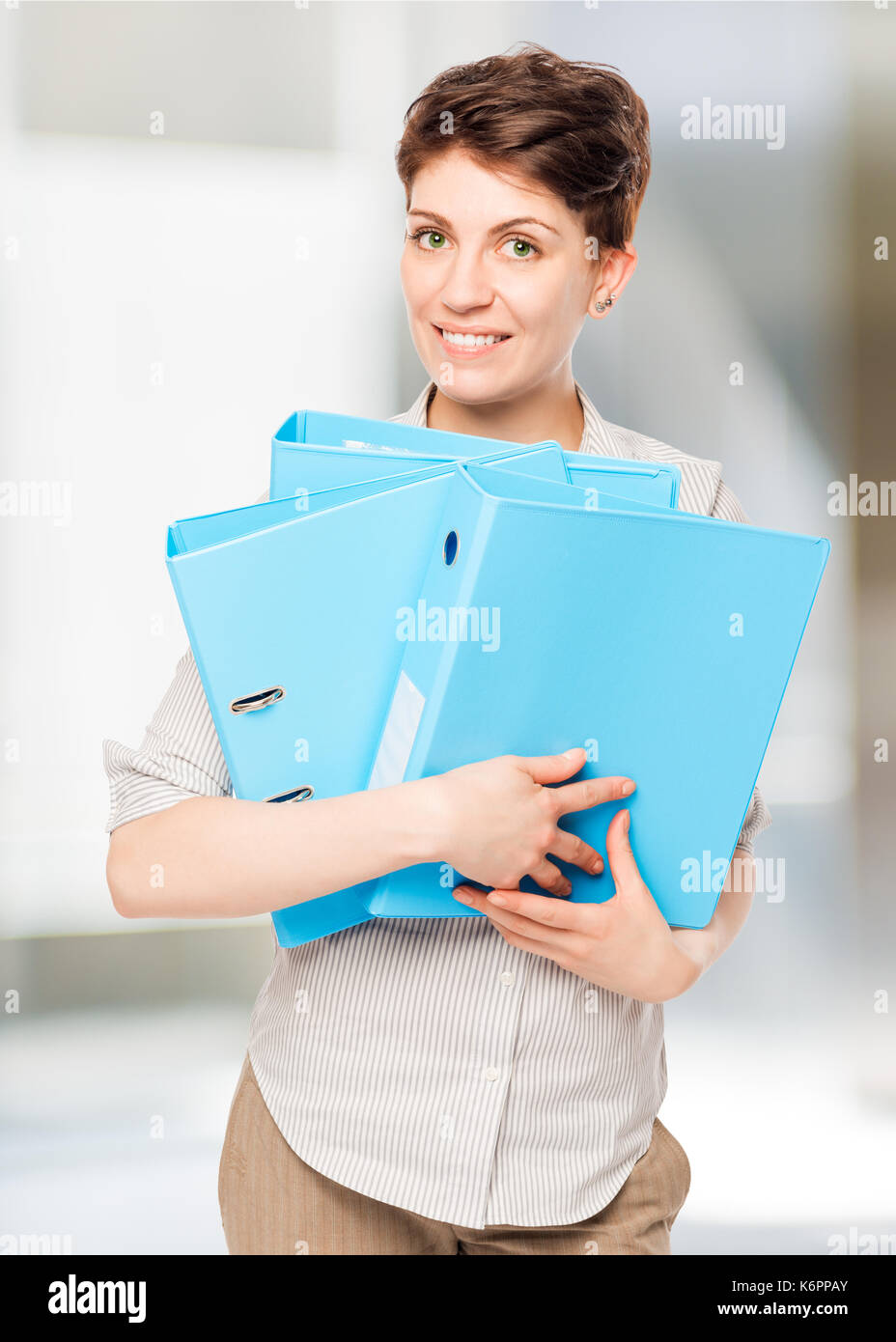 happy girl with blue folders for documents in the office Stock Photo ...