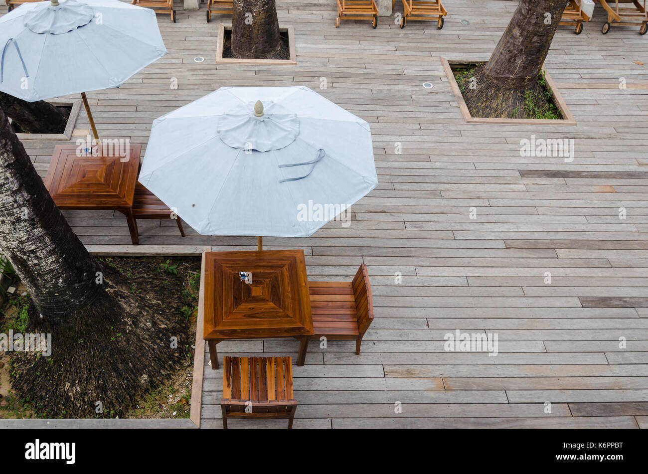 Top view of the umbrella and chairs under the trees Stock Photo - Alamy