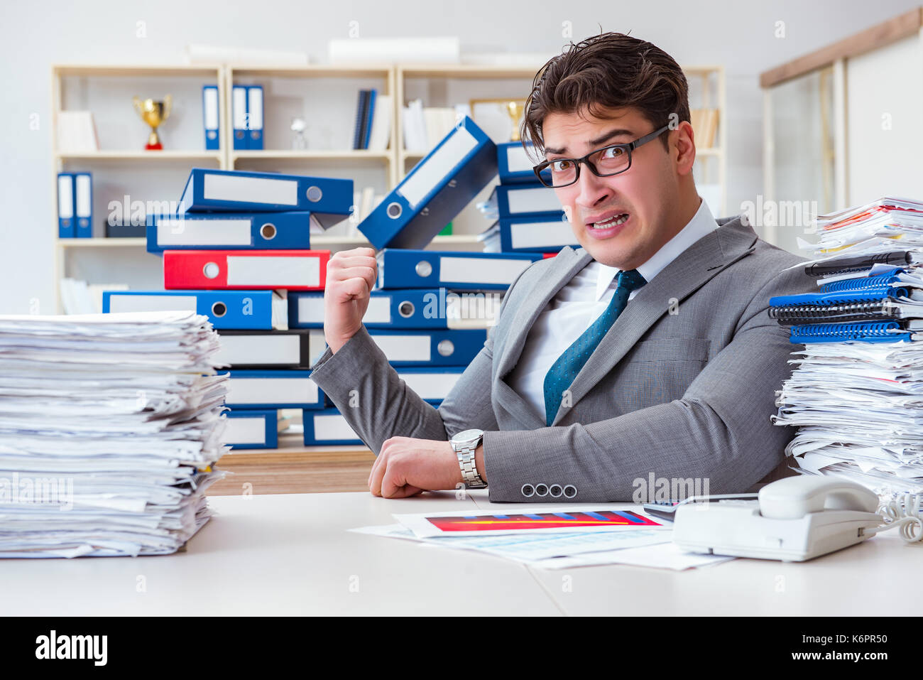 Businessman busy with much paperwork Stock Photo - Alamy