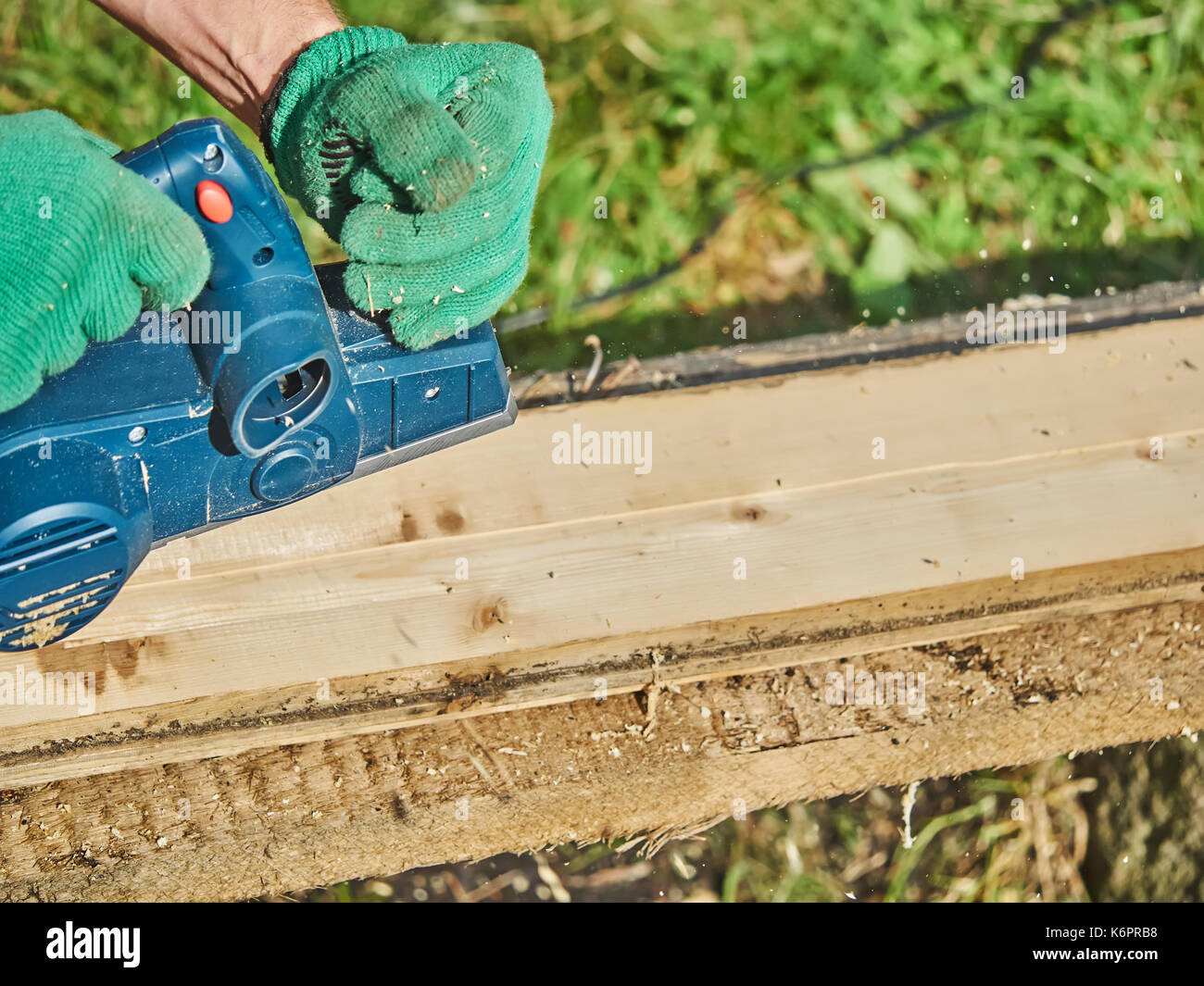 The builder plots the board with an electric plane Stock Photo - Alamy