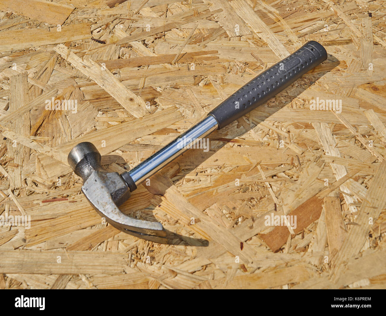 Hammer on a wooden background Stock Photo - Alamy