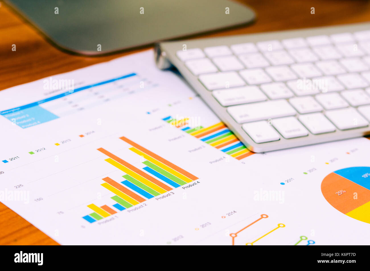 Office desk workplace with graph and keyboard on desk Stock Photo - Alamy