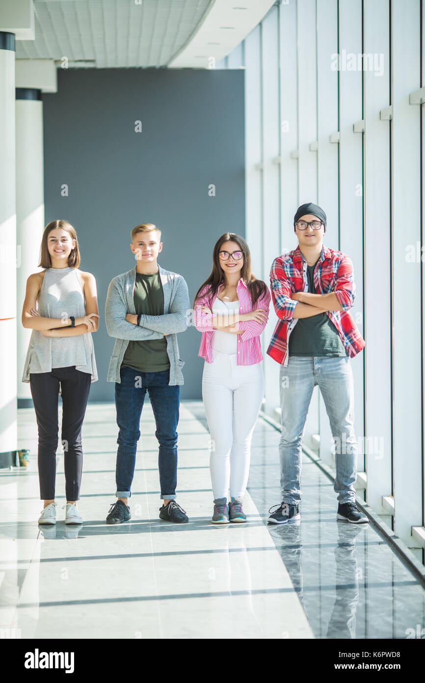 Four friends standing and smiling. Four friends standing. Fours ...