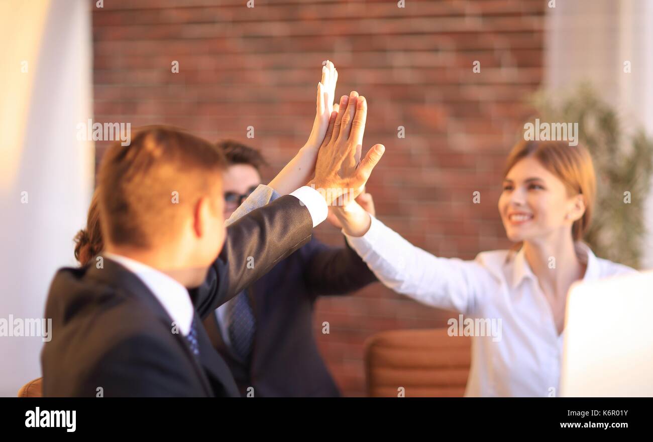 successful business team giving each other a high five Stock Photo - Alamy