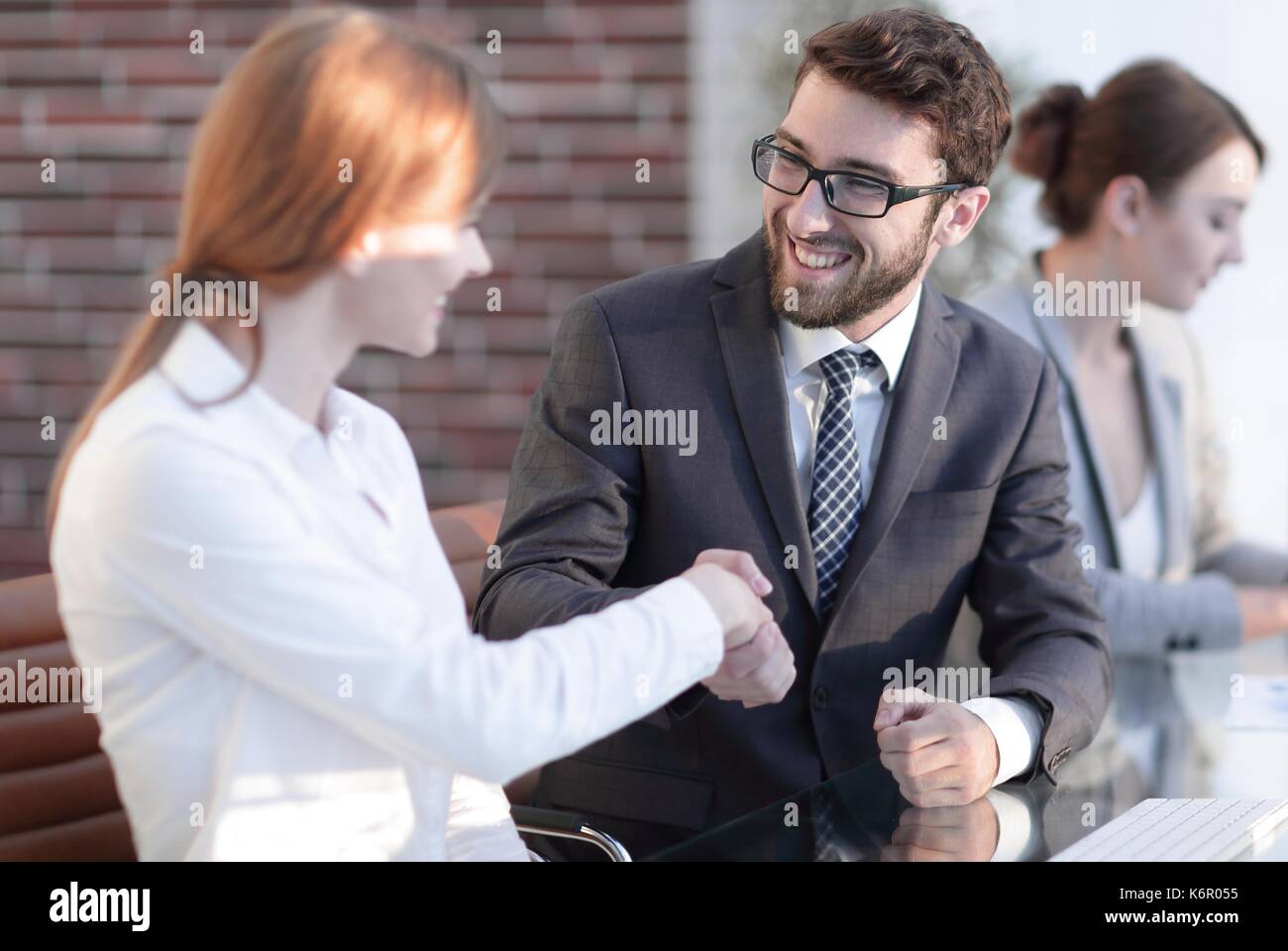 friendly handshake between colleagues in the office Stock Photo - Alamy