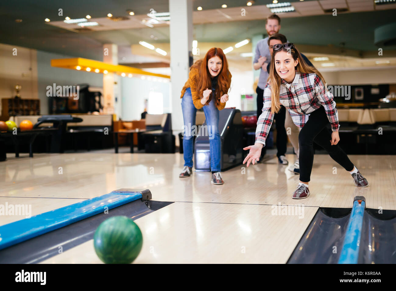 Friends bowling at club Stock Photo - Alamy
