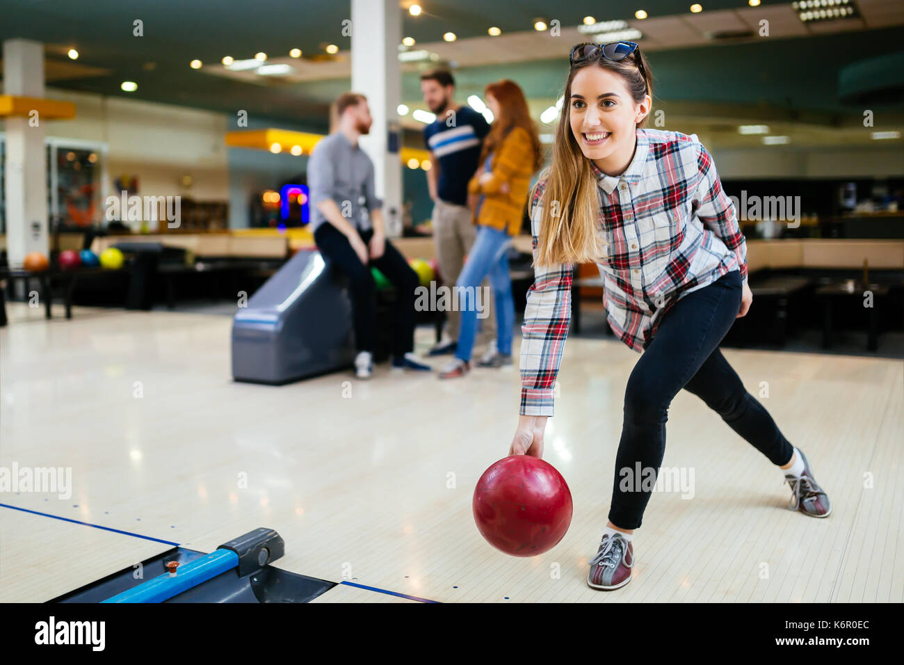Beautiful woman bowling with friends Stock Photo - Alamy