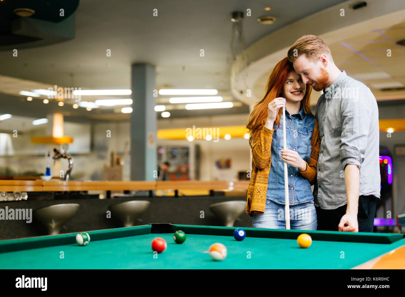 Couple dating and playing snooker Stock Photo - Alamy