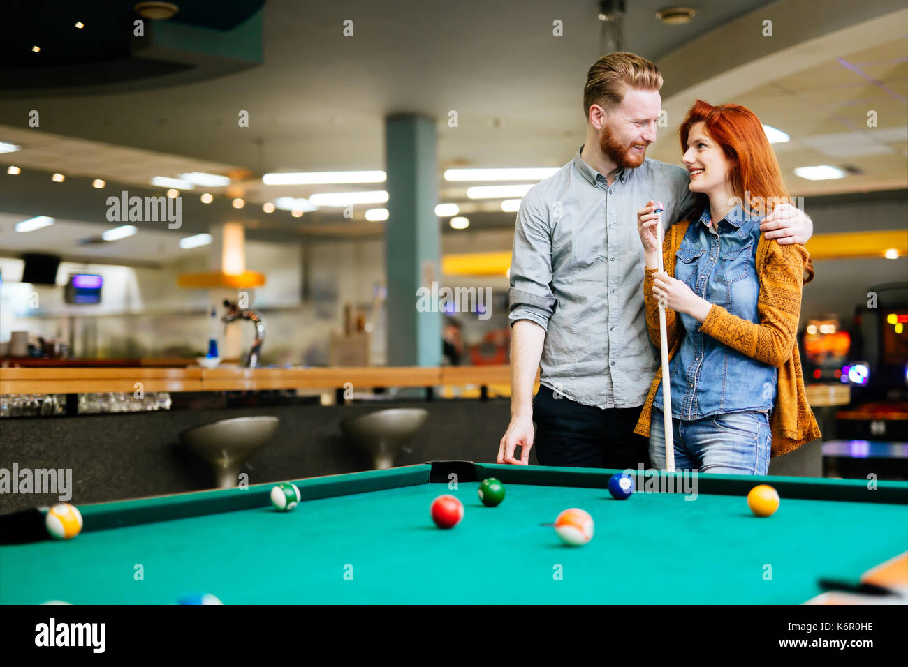 Beautiful couple playing billiards Stock Photo - Alamy
