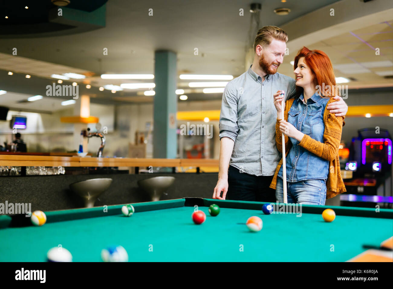 Couple dating and playing snooker Stock Photo - Alamy