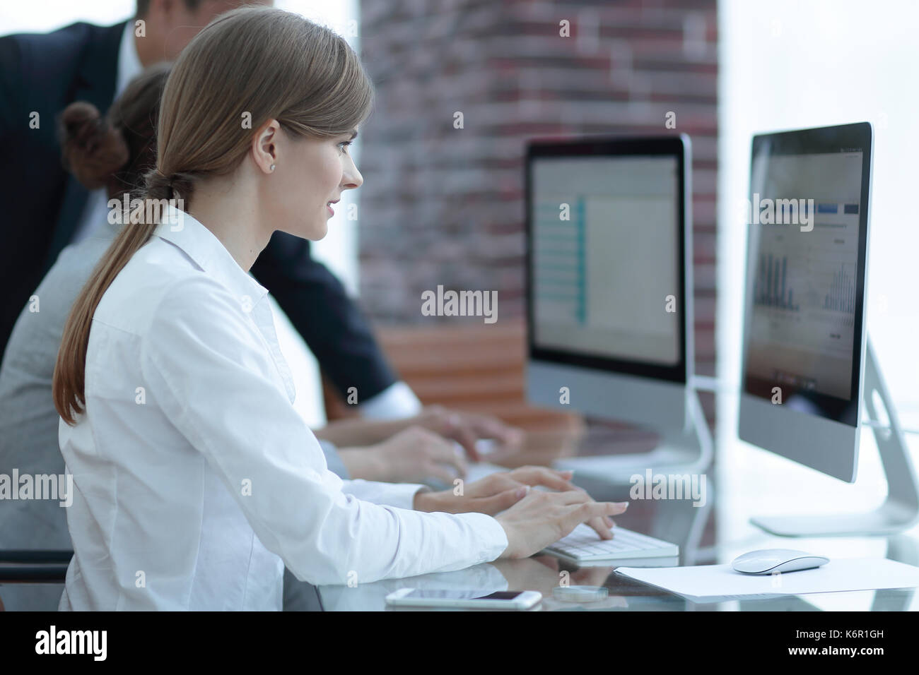 employees working on personal computers with financial data Stock Photo ...