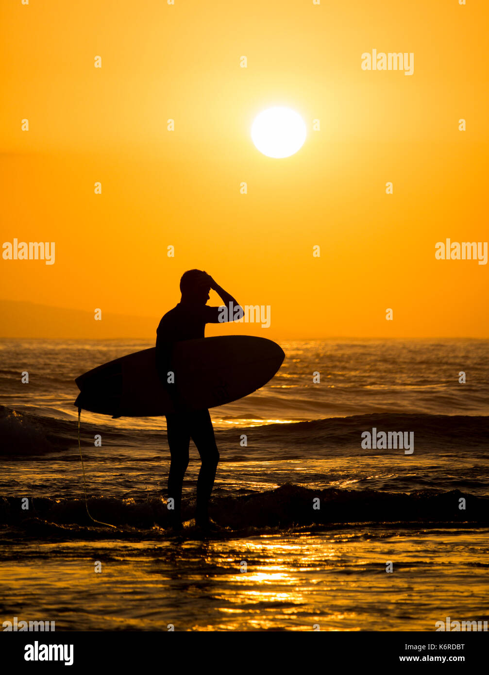 Surfer at sunset Stock Photo - Alamy