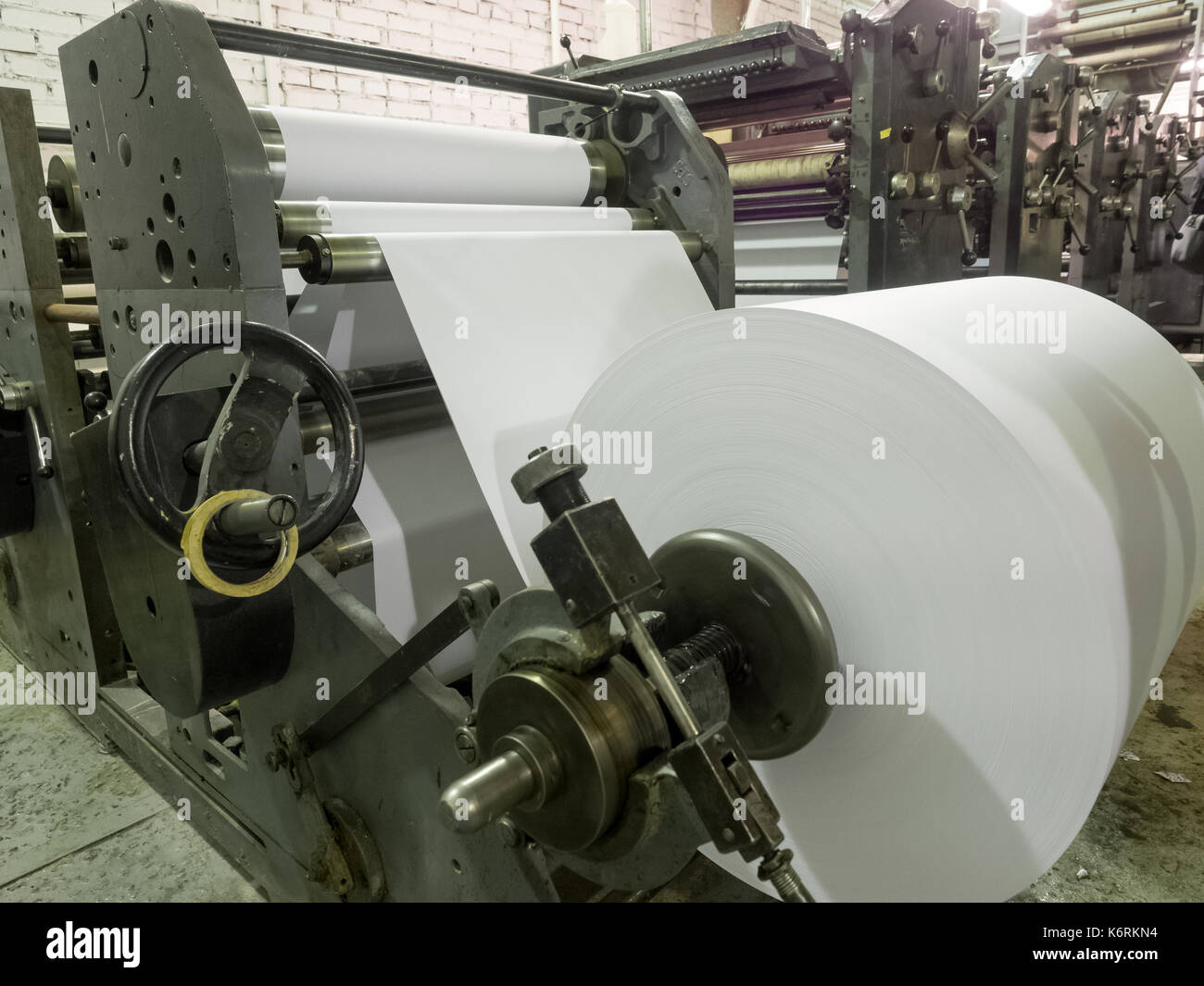 A roll of paper installed in a typographic machine Stock Photo - Alamy