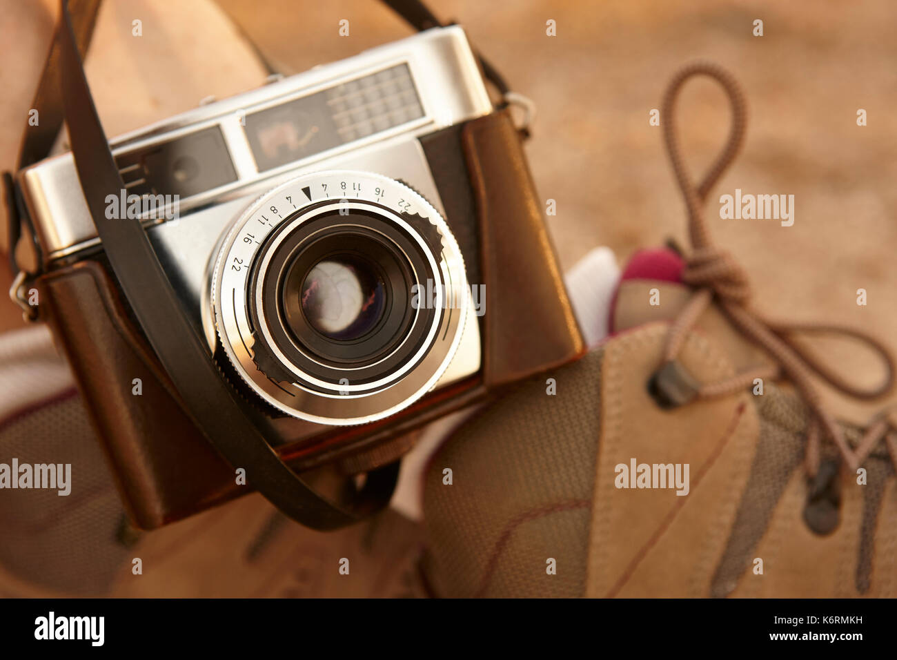 Vintage camera with hiking boots on the ground. Travel background Stock ...