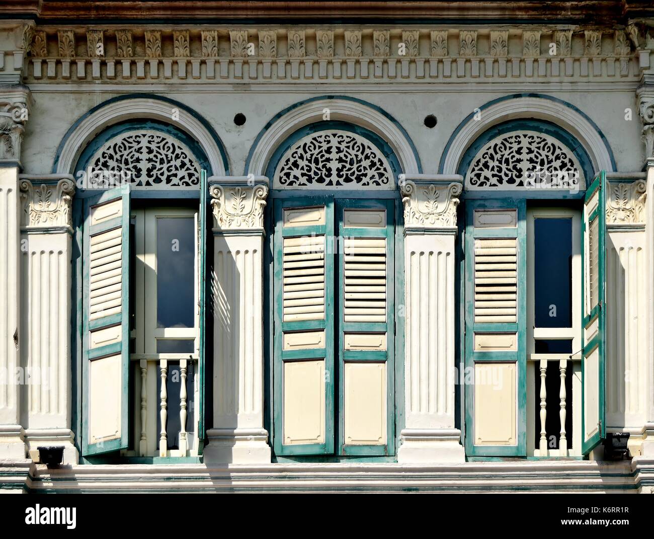 Traditional Singapore shop house exterior with arched windows, wooden ...