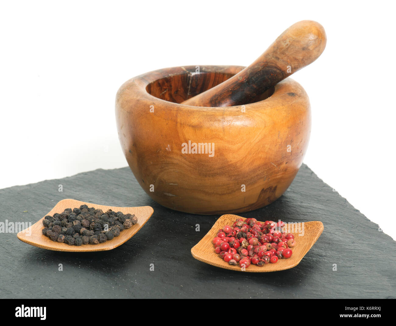 pepper and pestle in front of white background Stock Photo - Alamy