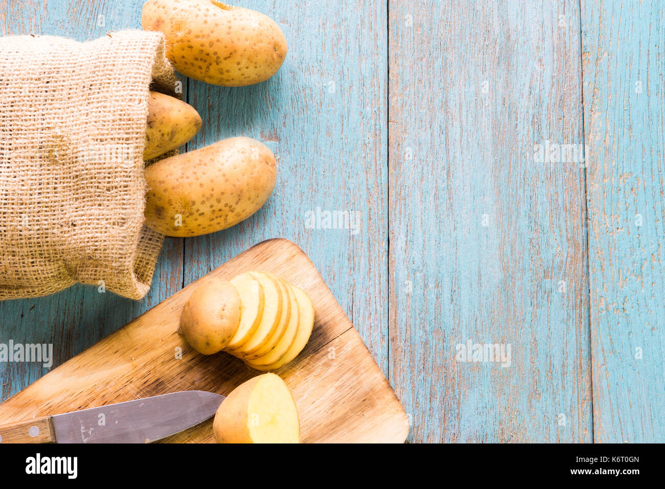 Pile of potatoes lying on wooden boards with a potato bag in the ...