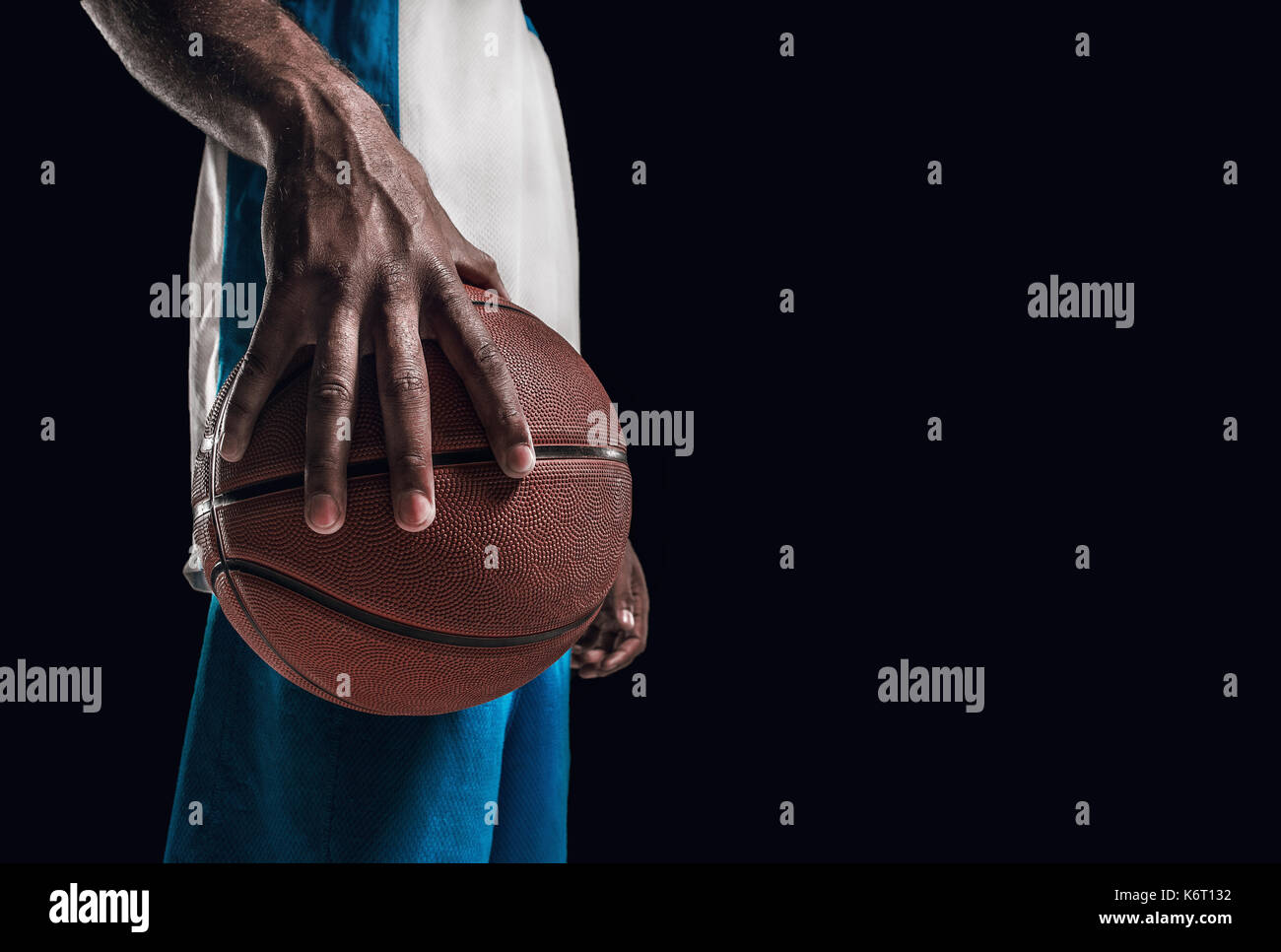 The hand of a basketball player with ball Stock Photo - Alamy