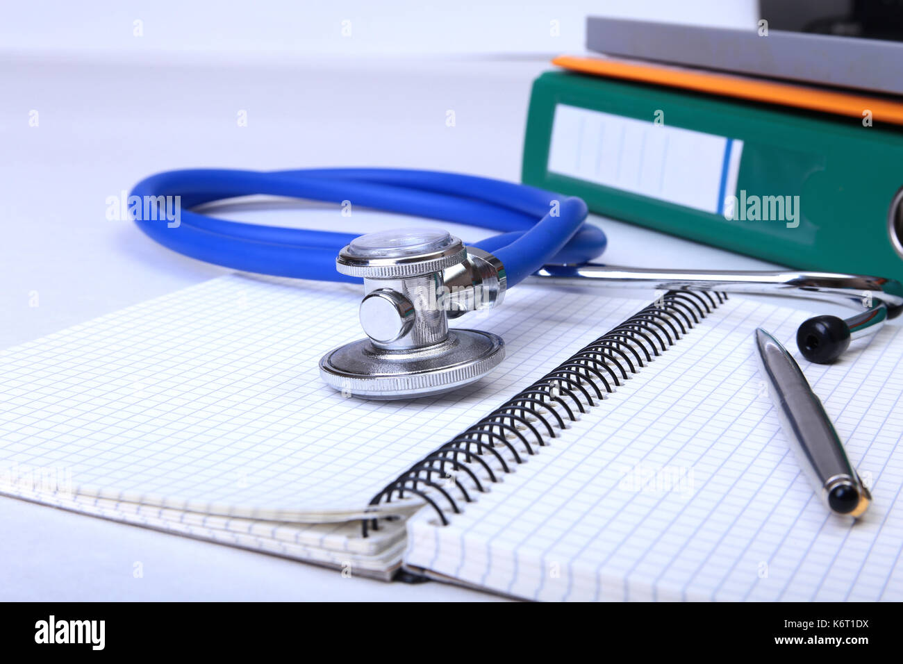Folder file, stethoscope and RX prescription on the desk. blurred ...