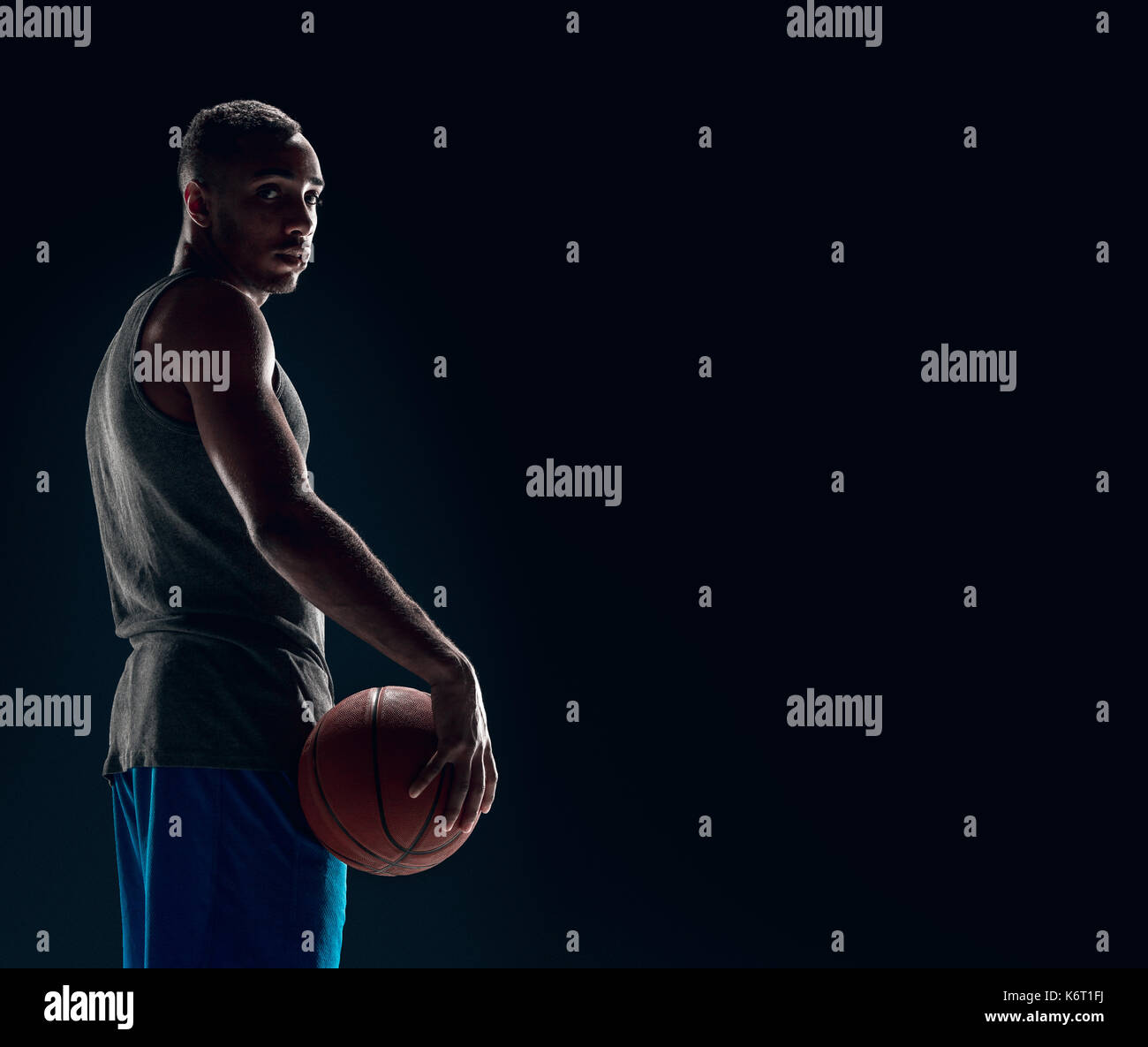 The portrait of a basketball player with ball Stock Photo - Alamy