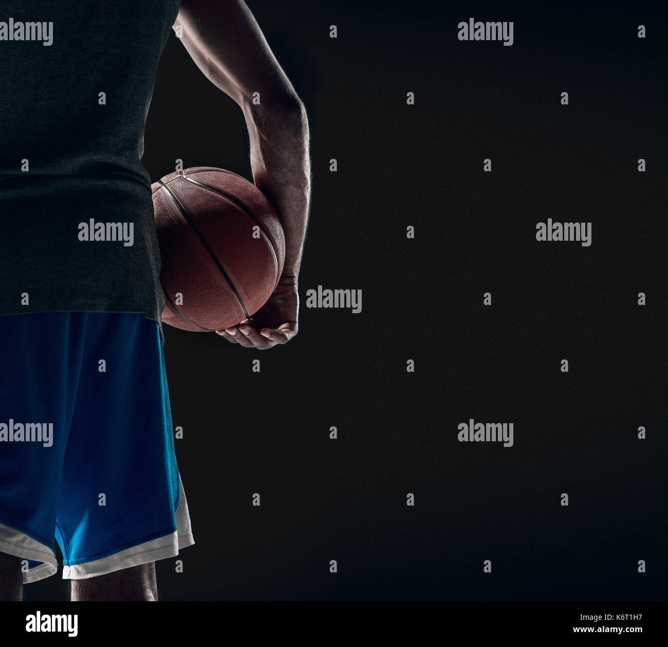 The hand of a basketball player with ball Stock Photo - Alamy