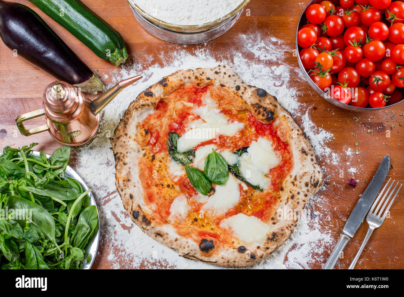 Traditional italian pizza with mozzarella, tomato and basil, on a ...