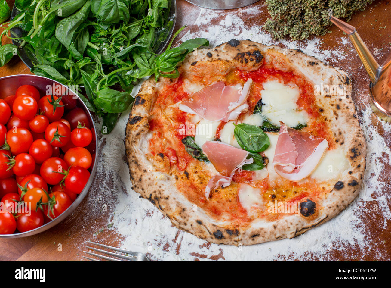 Traditional italian pizza with mozzarella, tomato, ham and ingredients ...