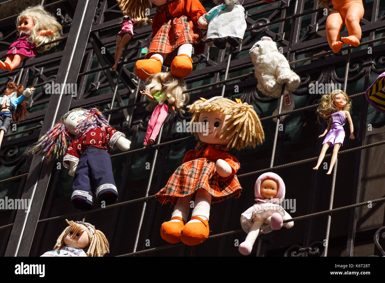Children's colorful soft toys hanging on strings at a market stall ...