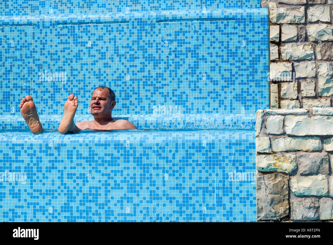 VENICE , ITALY - 2 JUNE 2017 : Man relaxing on the swimming pool in the ...